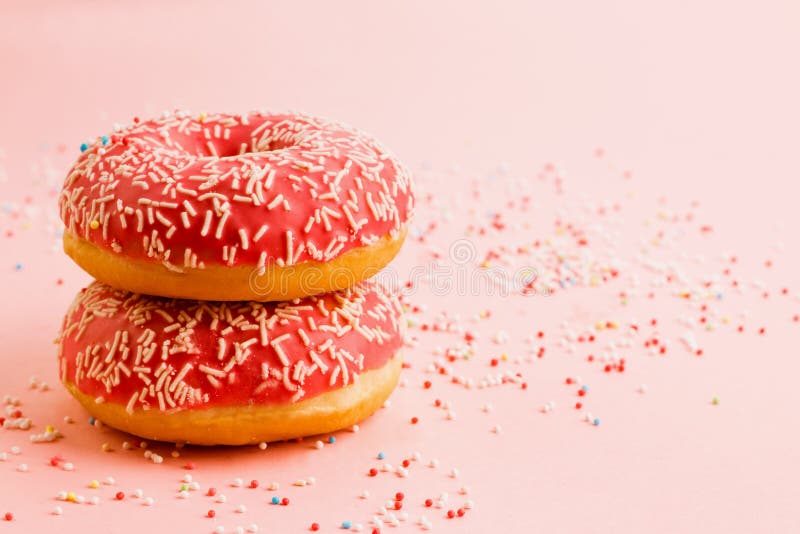 Two Coral Donuts Standing in a Line. Donuts Decorated with Icing Stock ...