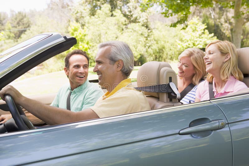 Two Couples in Convertible Car Smiling Stock Photo - Image of ...