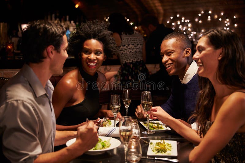 Group of Friends Enjoying Meal in Restaurant Stock Image - Image of ...