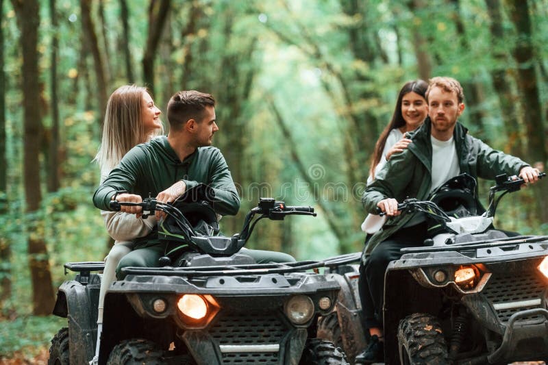 Two Couples on a Quad Bike in the Forest during the Day Stock Photo ...