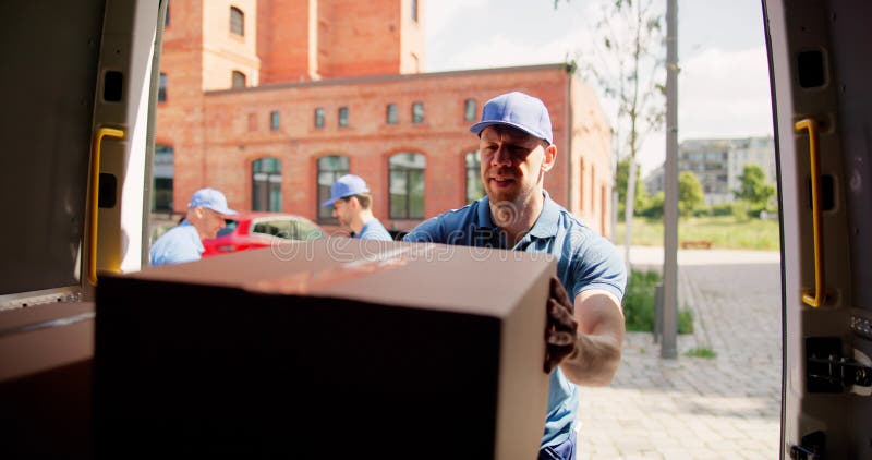 Two Couriers Loading Cardboard Boxes for Moving Service Transporting ...