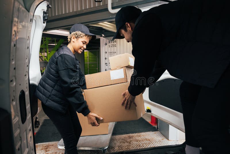 Two Couriers Stack Cardboard Boxes in a Delivery Van. Coworkers Pick Up ...