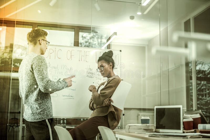 Two Coworkers Discussing Topic of the Day in Their Modern Office Stock ...