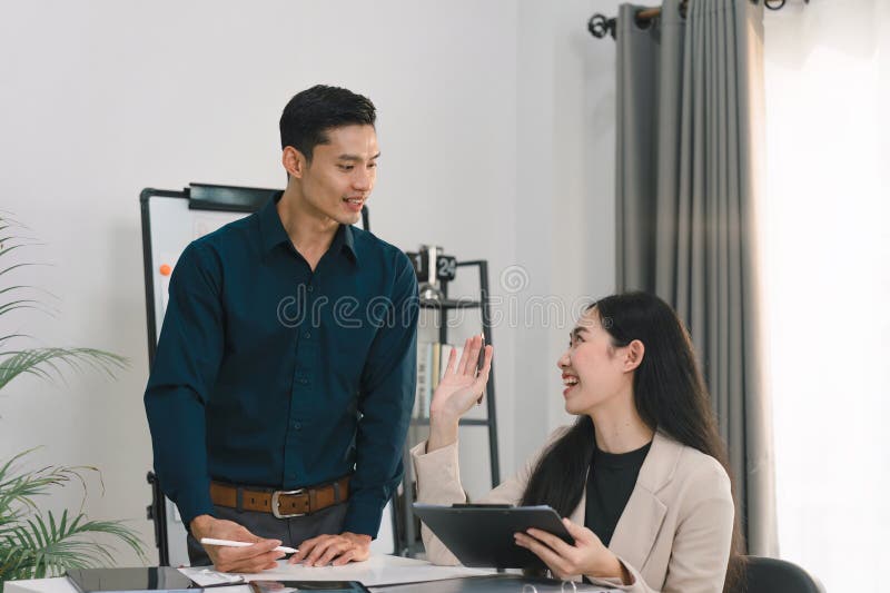 Two Coworkers Having a Friendly Discussion in the Modern Office about a ...