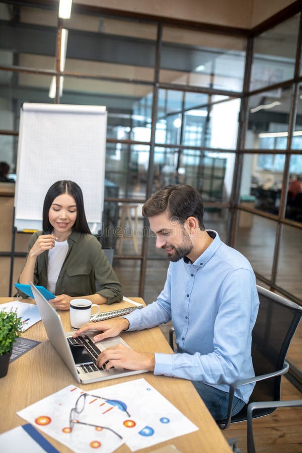 Two Coworkers Sitting at the Table and Working Together Stock Image ...