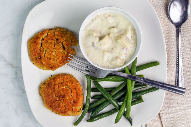 Two Crab Cakes with Green Beans and Chowder Stock Photo - Image of ...