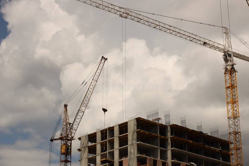 Two Crane Operators in Overalls Repair a High-rise Tower Crane Working ...