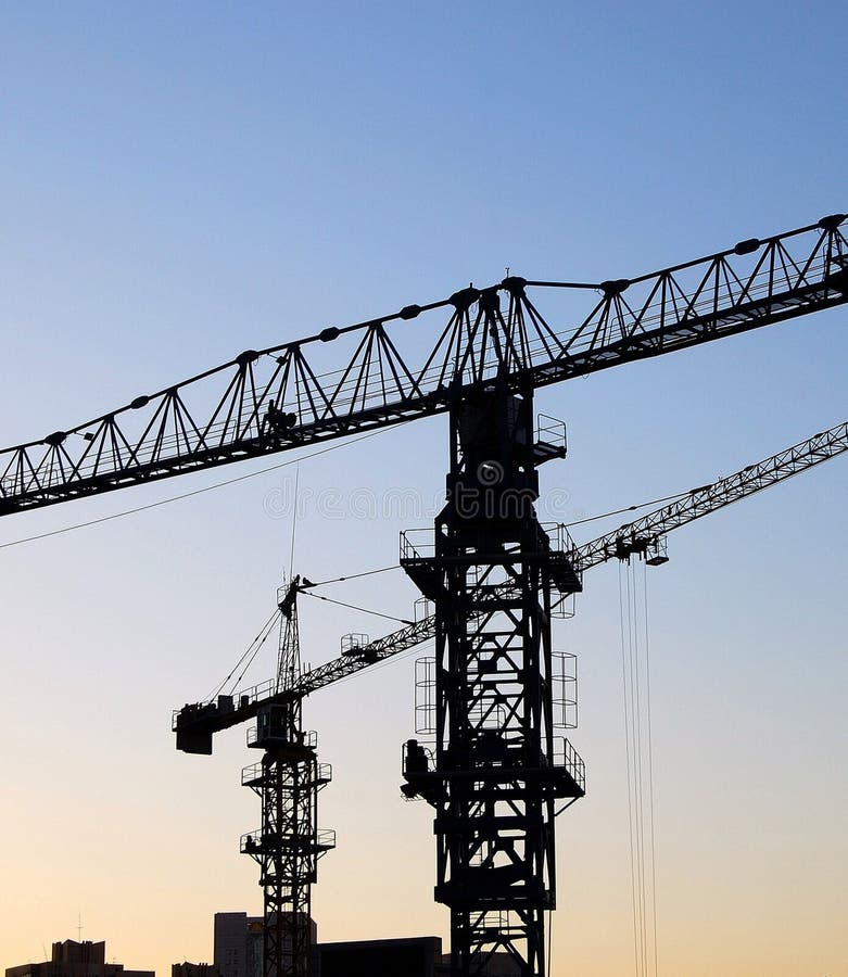Two Cranes at Sunset at the Construction Site Stock Photo - Image of ...