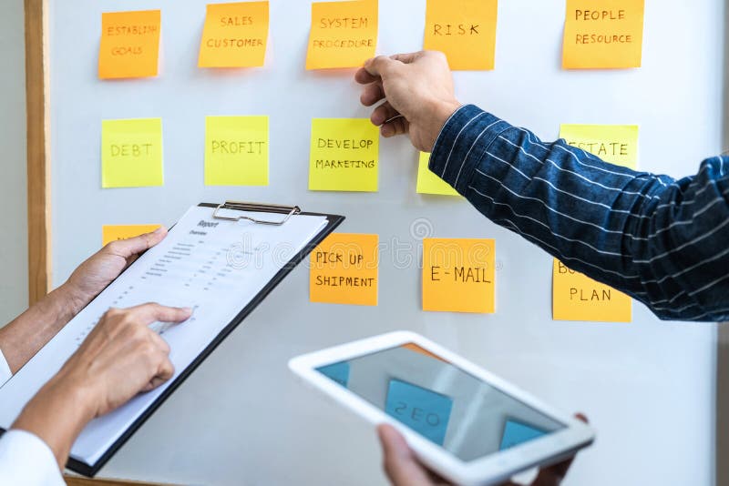 Two Creative Business People Meeting and Planning Use Post it Notes ...