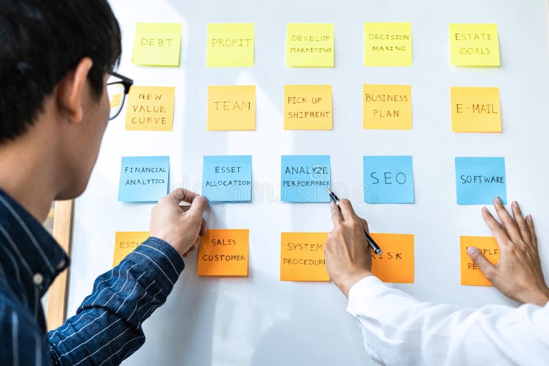 Two Creative Business People Meeting and Planning Use Post it Notes ...