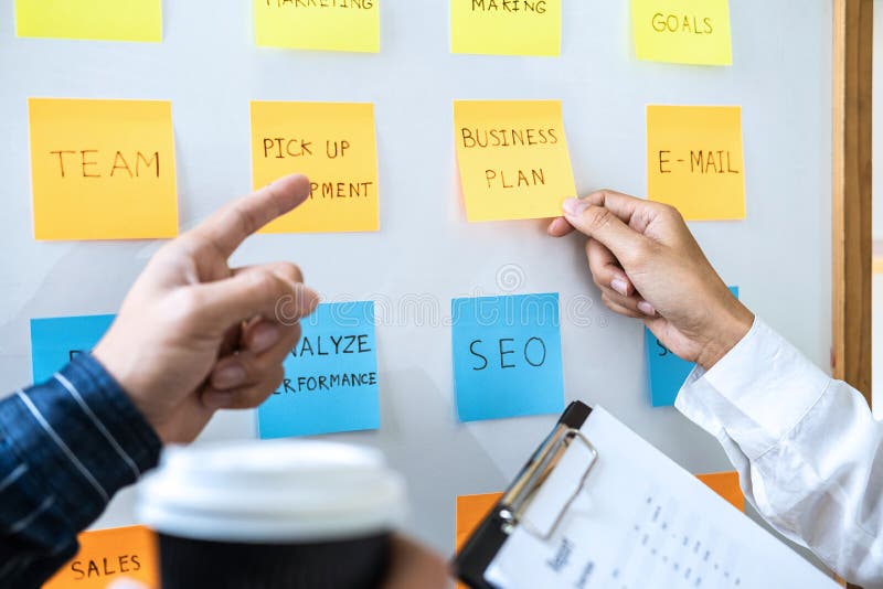 Two Creative Business People Meeting and Planning Use Post it Notes ...