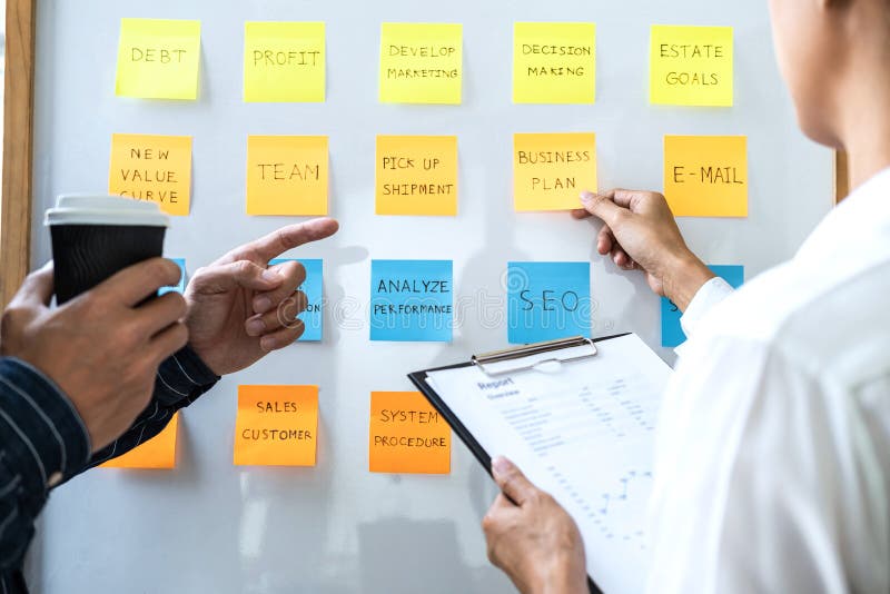 Two Creative Business People Meeting and Planning Use Post it Notes ...