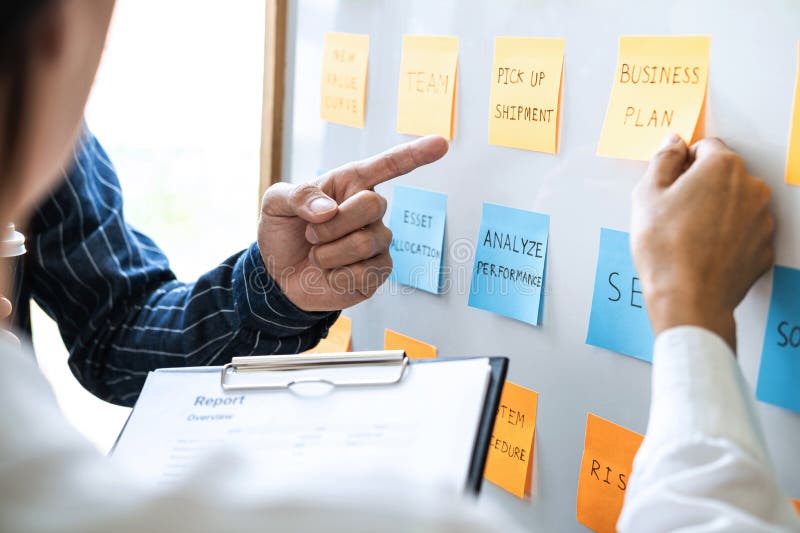 Two Creative Business People Meeting and Planning Use Post it Notes ...