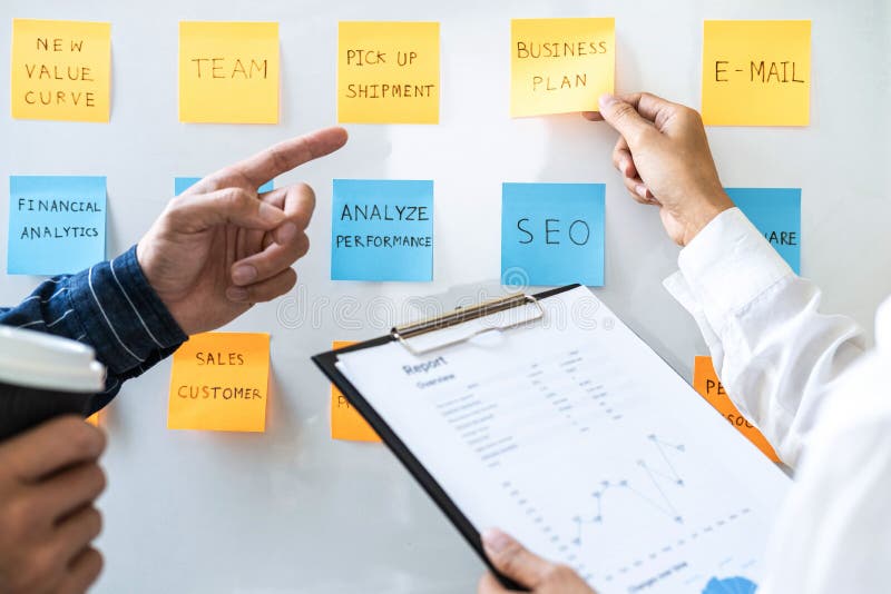 Two Creative Business People Meeting and Planning Use Post it Notes ...