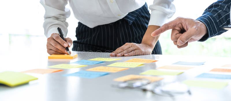 Two Creative Business People Meeting and Planning Use Post it Notes ...