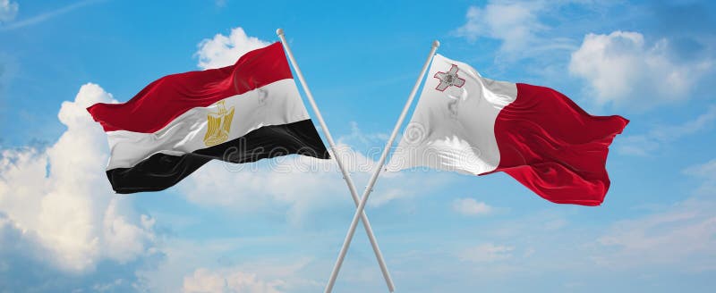 Two Crossed Flags Malta and Egypt Waving in Wind at Cloudy Sky. Concept ...