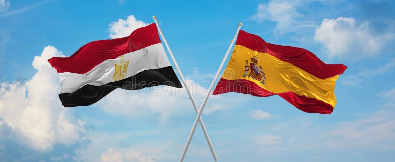 Two Crossed Flags Spain and Egypt Waving in Wind at Cloudy Sky. Concept ...