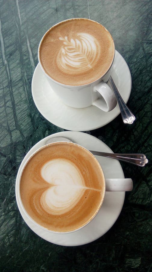 Two Cups of Coffee Latte with Art on a Table Stock Photo - Image of ...