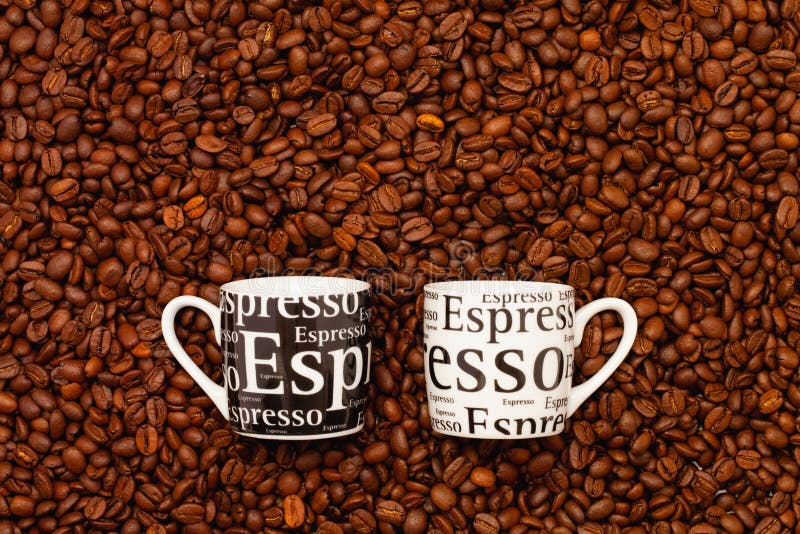 Two Cups of Coffee on a Table Full of Coffee Beans Stock Photo - Image ...