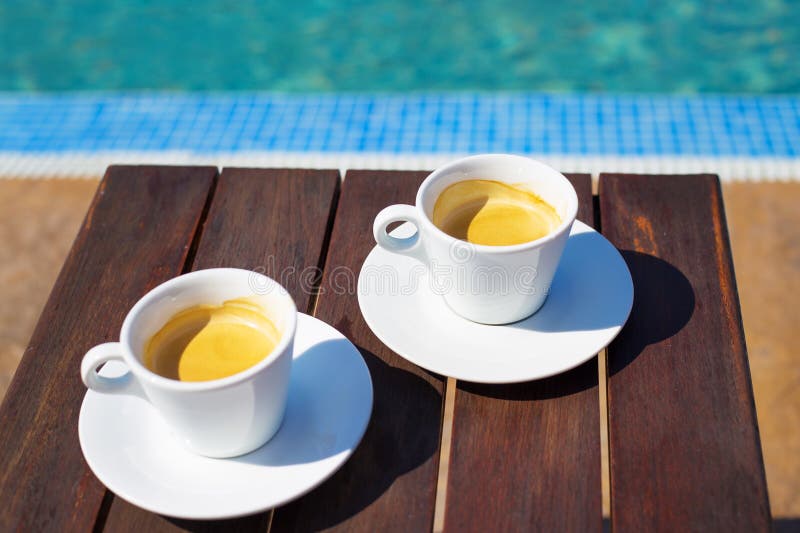 Two Cups of Coffee on the Table Near the Pool. Stock Image - Image of ...