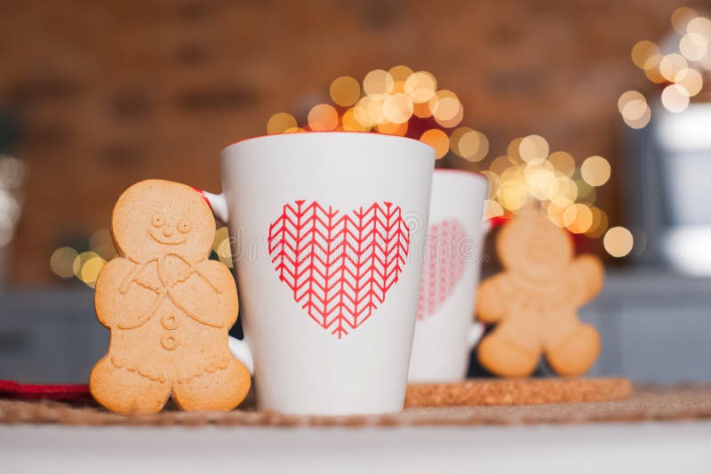 Two Cups and Gingerbread Men on Table with Garlands Blurred Background ...