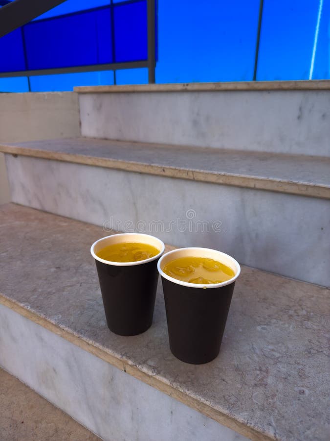 Two Cups of Refreshing Beverage Placed on Marble Steps with a Vibrant ...