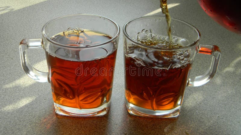 Two Cups of Tea and a Jet of Tea. Stock Image - Image of aroma, cups ...