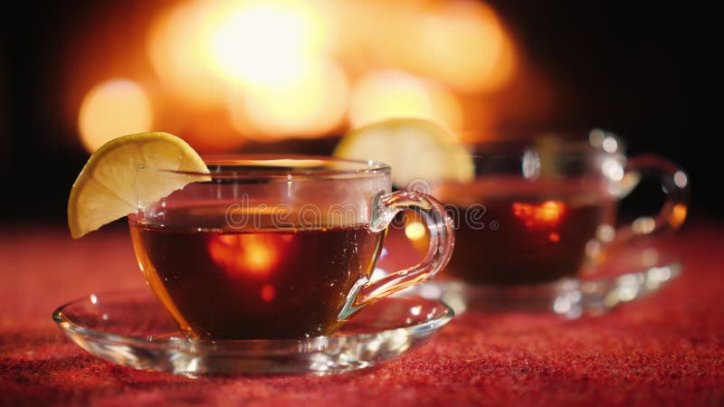 Two Cups with Tea and Lemon on the Background of the Fireplace Where ...