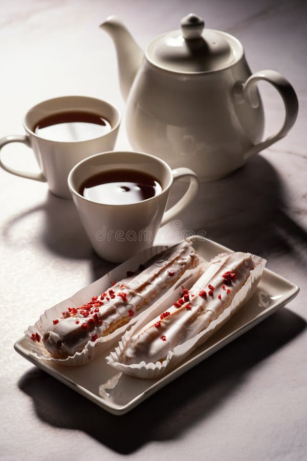 Two Cups of Tea and a Teapot are Placed on a Table. in Front of Them ...
