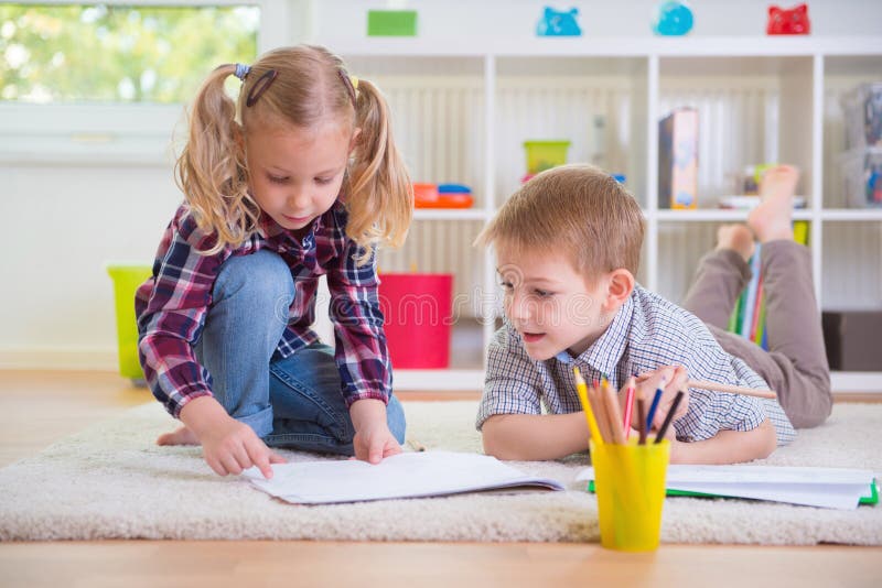 Two cute children at home stock photo. Image of book - 60074866
