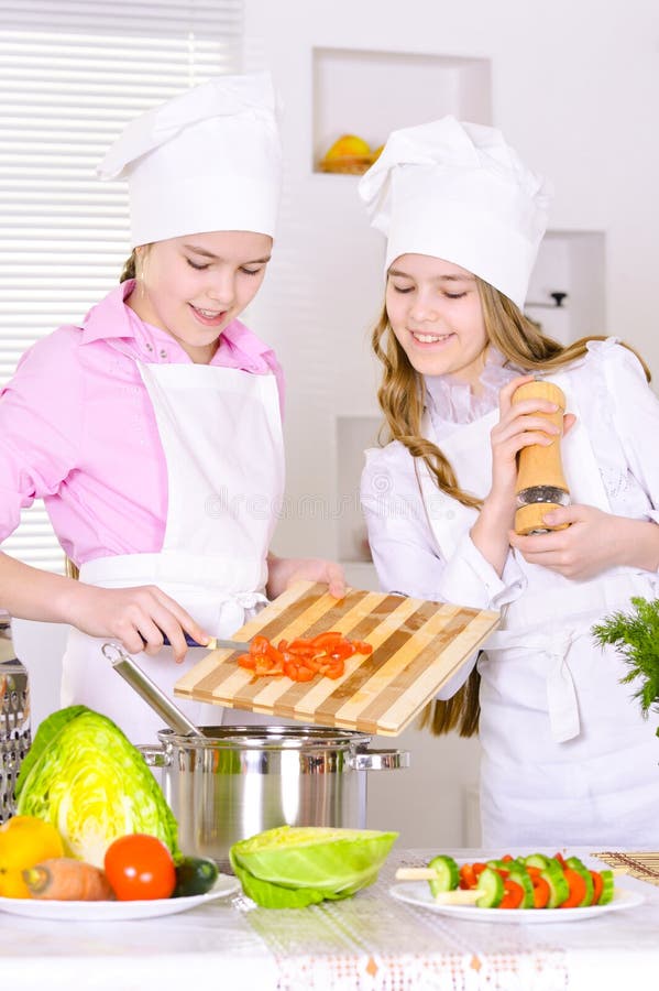 Two cute girls cooking stock image. Image of beautiful - 117206175