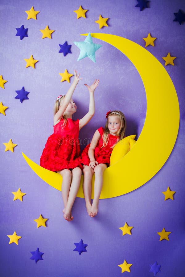 Two Cute Girls Sitting on a Big Moon Stock Image - Image of planet ...