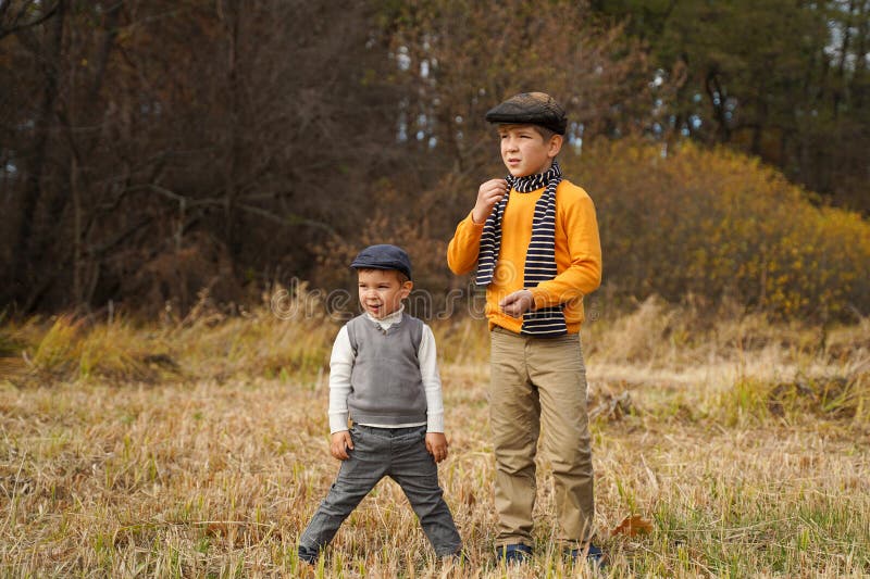 Two Cute Guys in Retro Clothes Posing in a Summer Field and Looking ...
