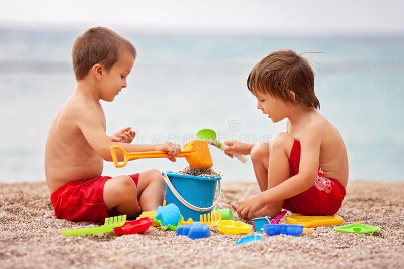 Two Cute Kids, Playing in the Sand on the Beach Stock Photo - Image of ...