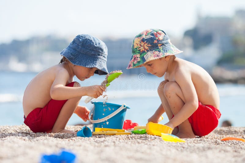 Two Cute Kids, Playing In The Sand On The Beach Stock Image - Image of ...