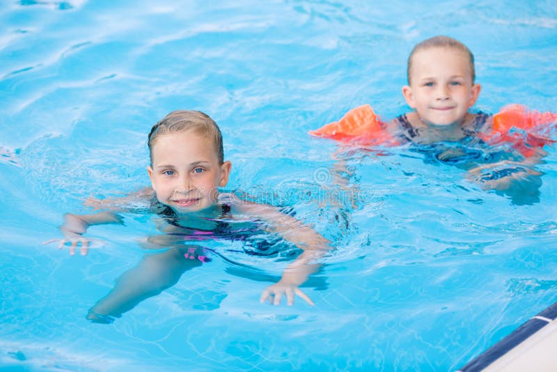 Two Cute Little Girls in Swimming Pool Stock Photo - Image of armlet ...