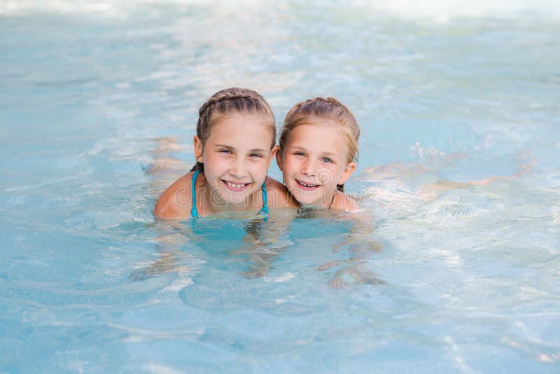 Two Cute Little Girls in Swimming Pool Stock Photo - Image of healthy ...