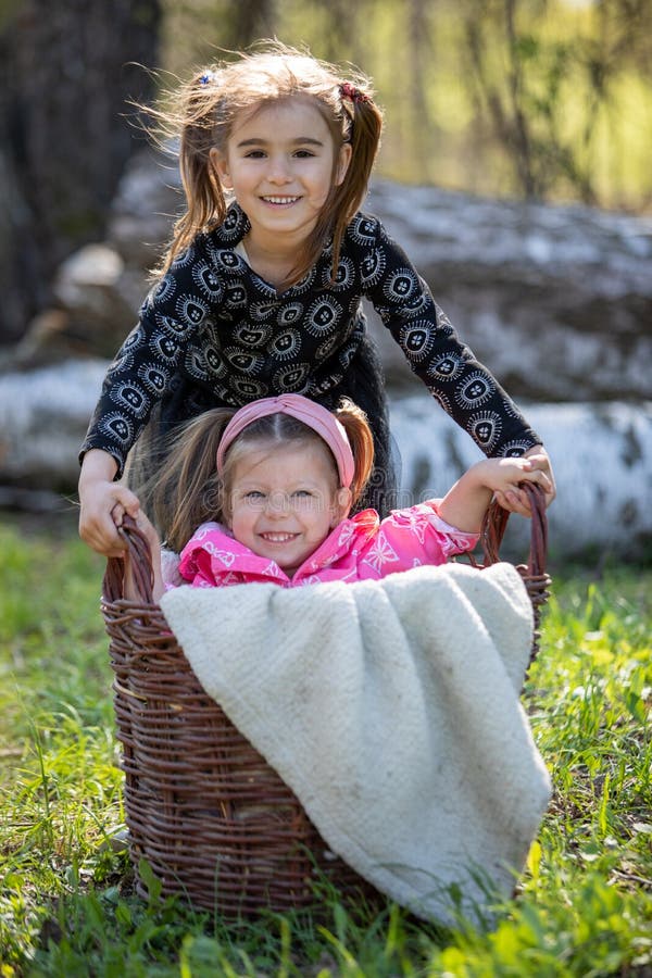Two Cute Sisters Having Fun Outside with Basket Stock Image - Image of ...