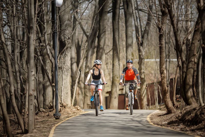 Two Cyclists Drive Around Park Stock Photo - Image of helmet, female ...