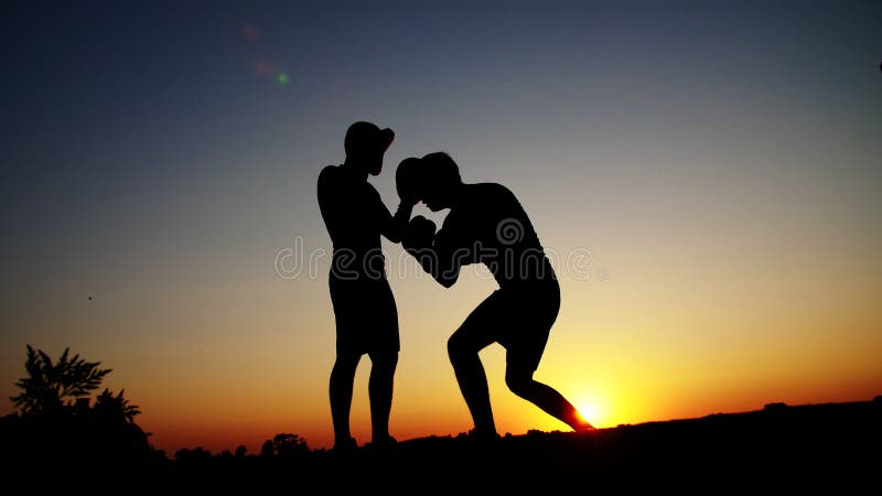 Two Dark Male Figures, at Sunrise, Against the Light, Boxing, Fighting ...