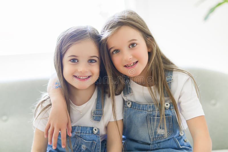 Two Daughter Child Sit on Sofa at Home Stock Photo - Image of children ...
