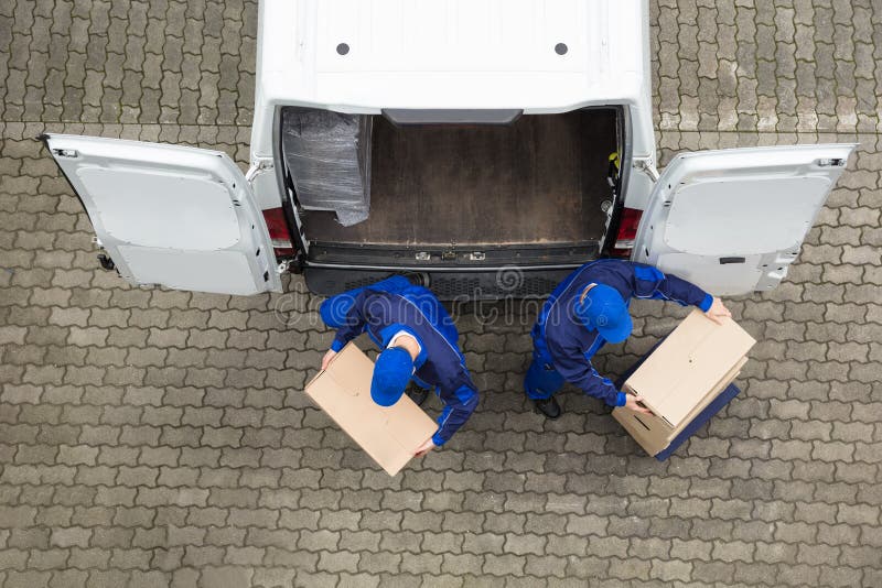 Two Delivery Men Unloading Cardboard Box from Truck Stock Image - Image ...