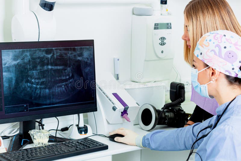 Dentists Examining a Dental Radiography on a Computer in a Dental ...
