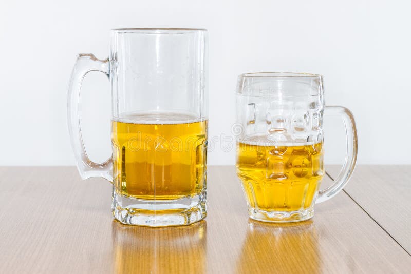 Two Different Beer Mugs Half Full with Lager Stock Photo - Image of ...