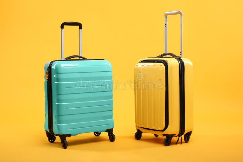 Two Different Bright Suitcases on Yellow Background Stock Image - Image ...