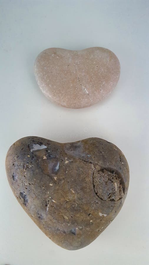 Two Different Hearts Made from Stone with a White Background Stock ...