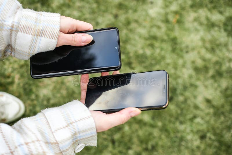 Two Different Phones in Woman S Hands, Choosing Better One, Outdoors ...