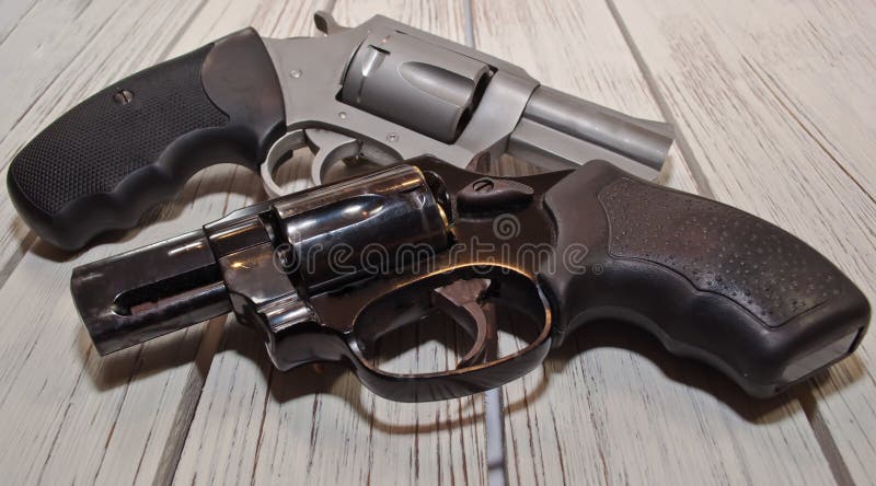 Two Different Revolvers on a Wooden Table Stock Photo - Image of ...