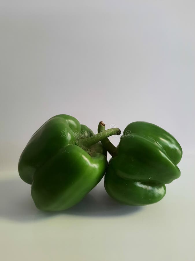 Two Different Sized Green Capsicum on Isolated White Background ...