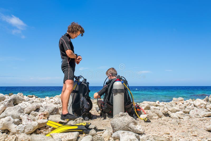 Two Divers on the Beach Prepare for Diving Stock Photo - Image of ...